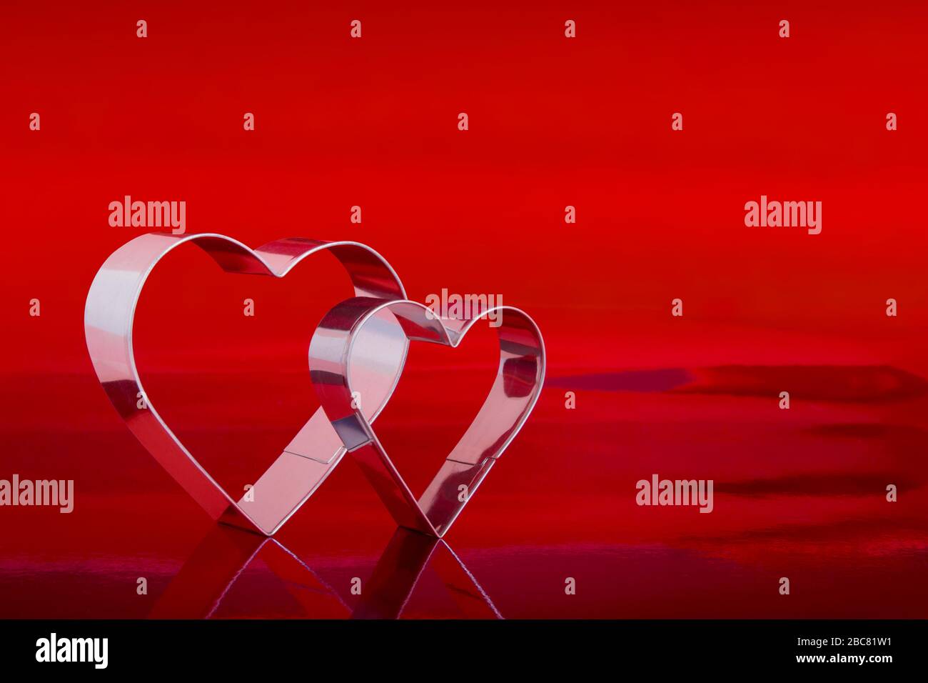 metal love heart shape cookie cutters on a red background Stock Photo ...