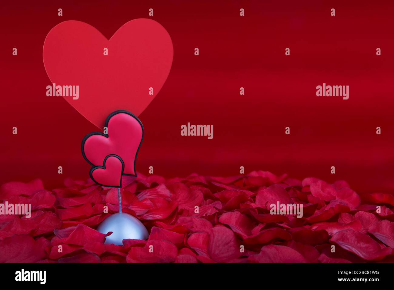 Blank Red Heart shape card with space for copy in the centre and held ...