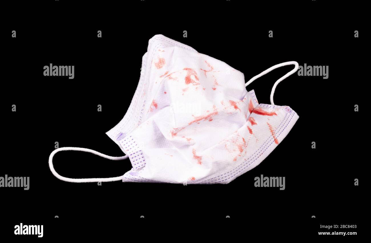 Bloody white mask for doctor, isolated on black background Stock Photo ...