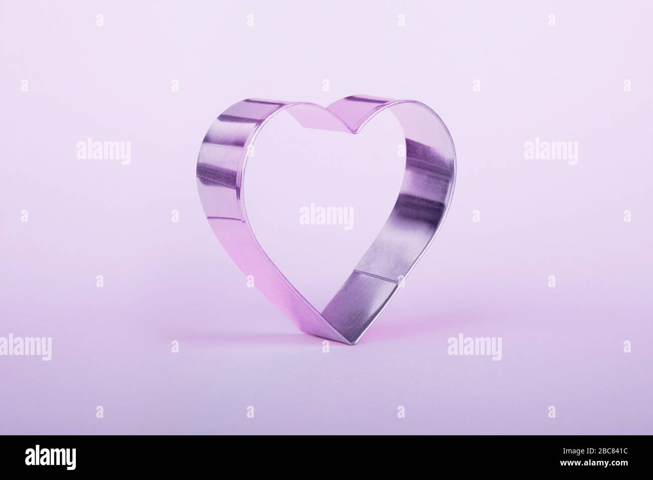metal love heart shape cookie cutter on a pink background Stock Photo ...