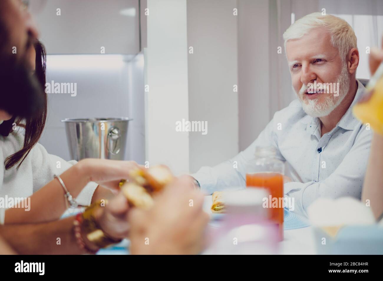 Handsome albino man looking at his friend while on a lunch Stock Photo ...