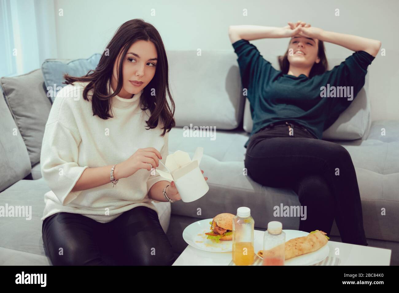 Girl eating pasta while her girlfriend is resting from the food Stock ...