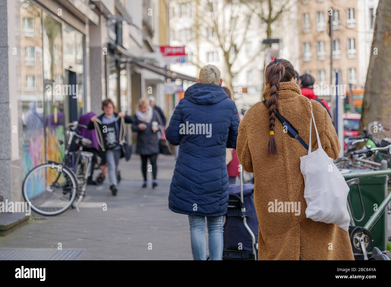 Selected focus, European people queue and wait outside store during ...