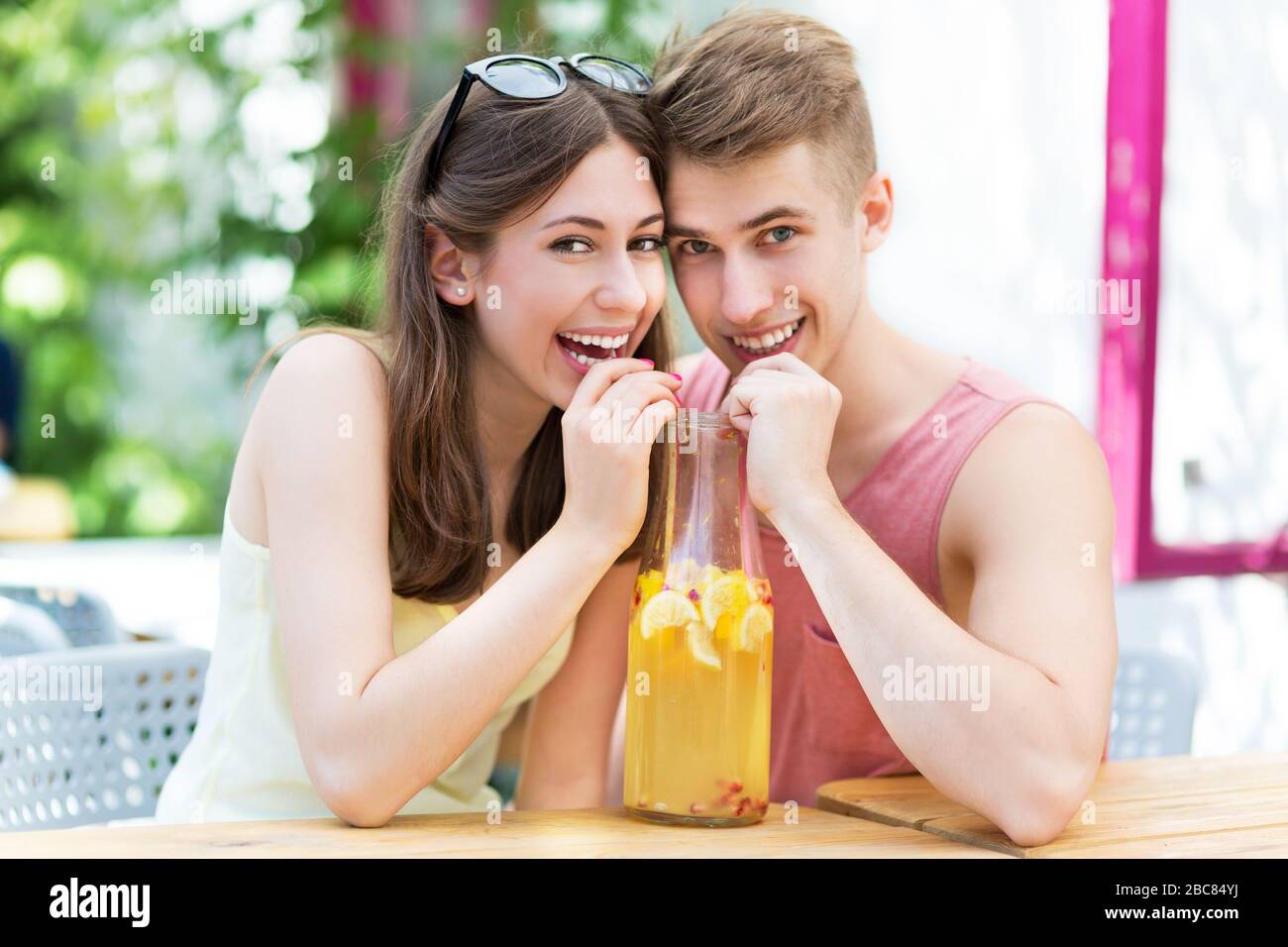 Couple sharing a drink hi-res stock photography and images - Alamy