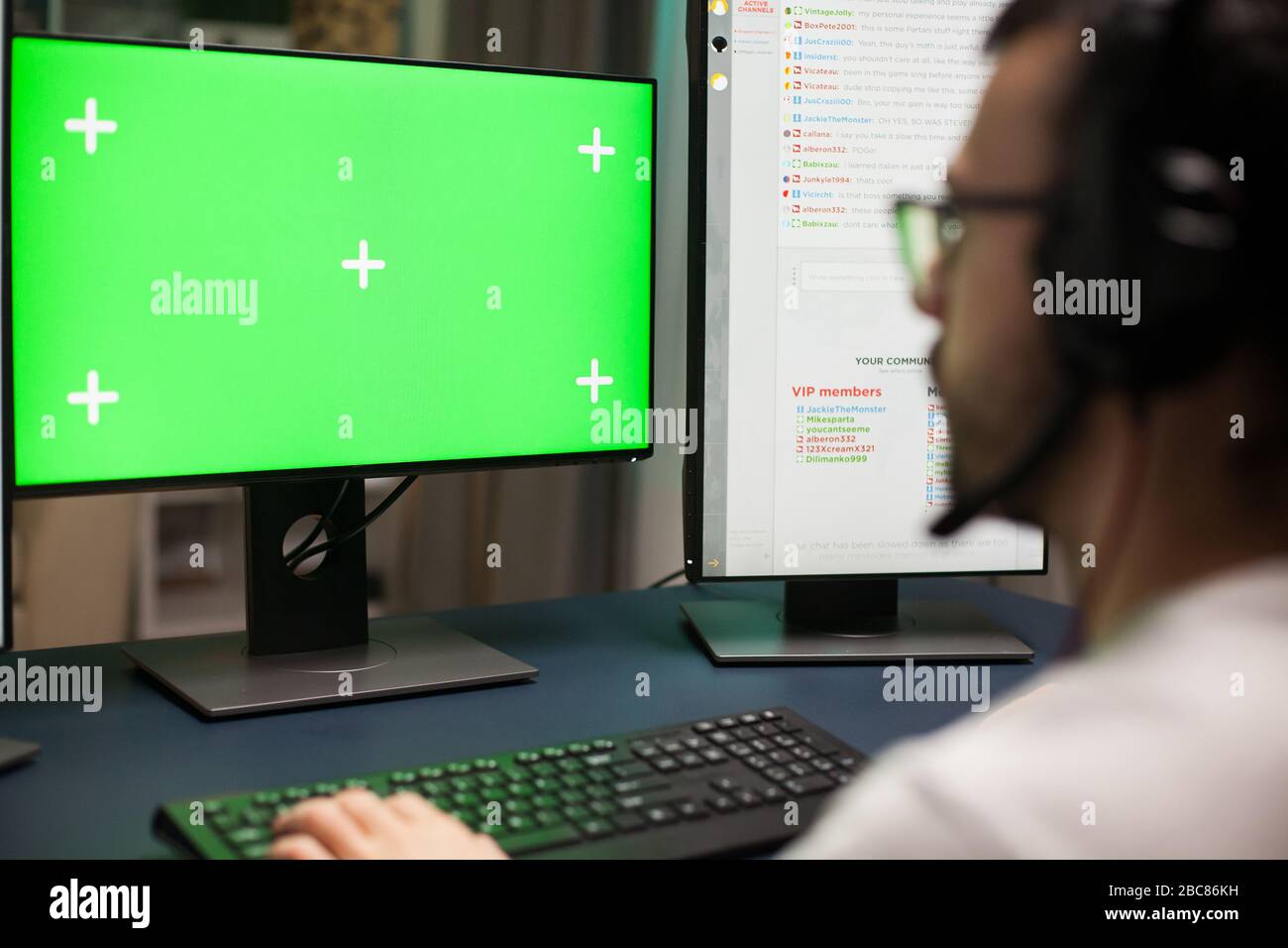 Close up young man playing games on computer with green screen Stock ...