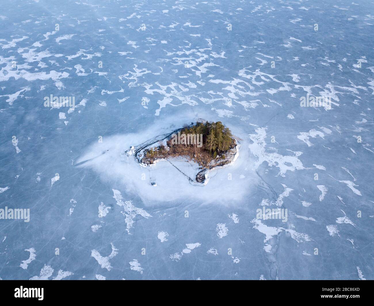 Small island at frozen lake Stock Photo - Alamy