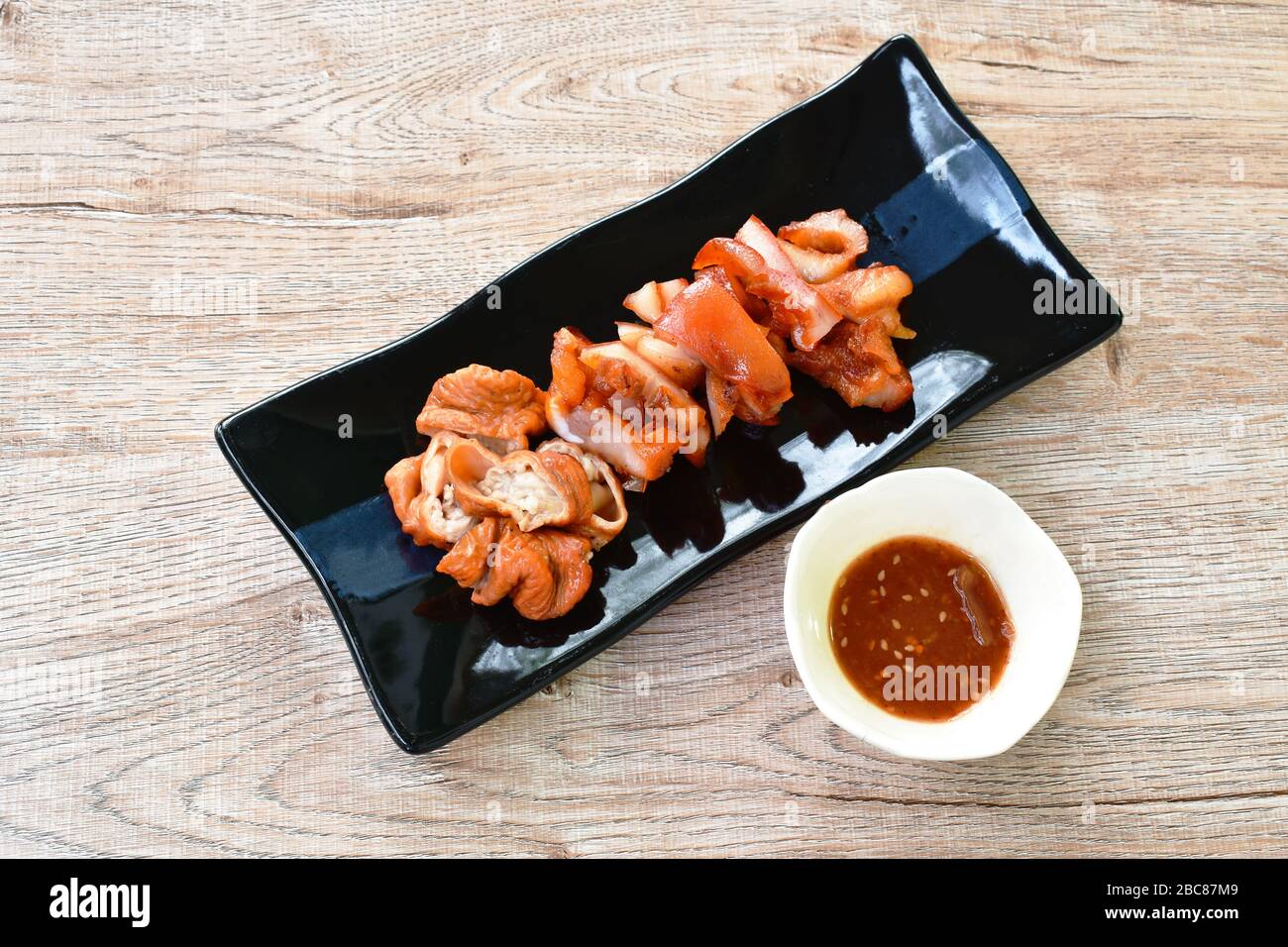 roasted pork neck and innards on plate dipping with tamarind sauce ...