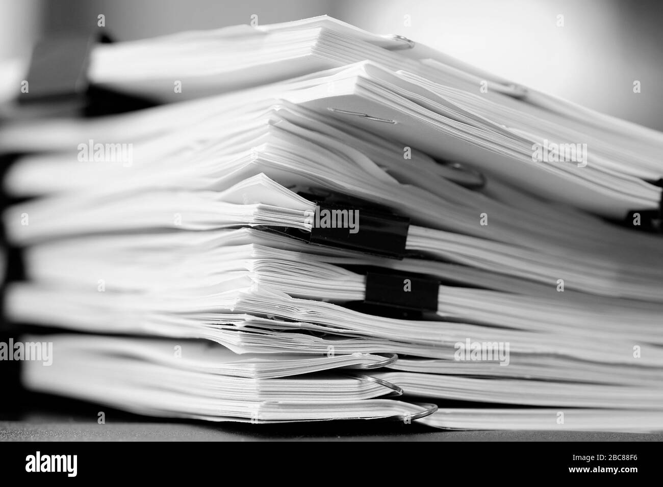 Pile of papers with binder clips paperclips business for organizing ...