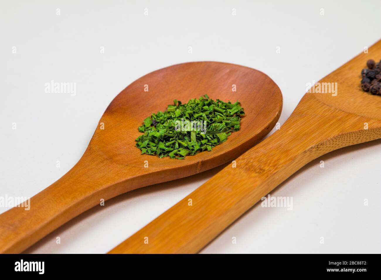 Wooden ladle with green herbs and spices Stock Photo - Alamy