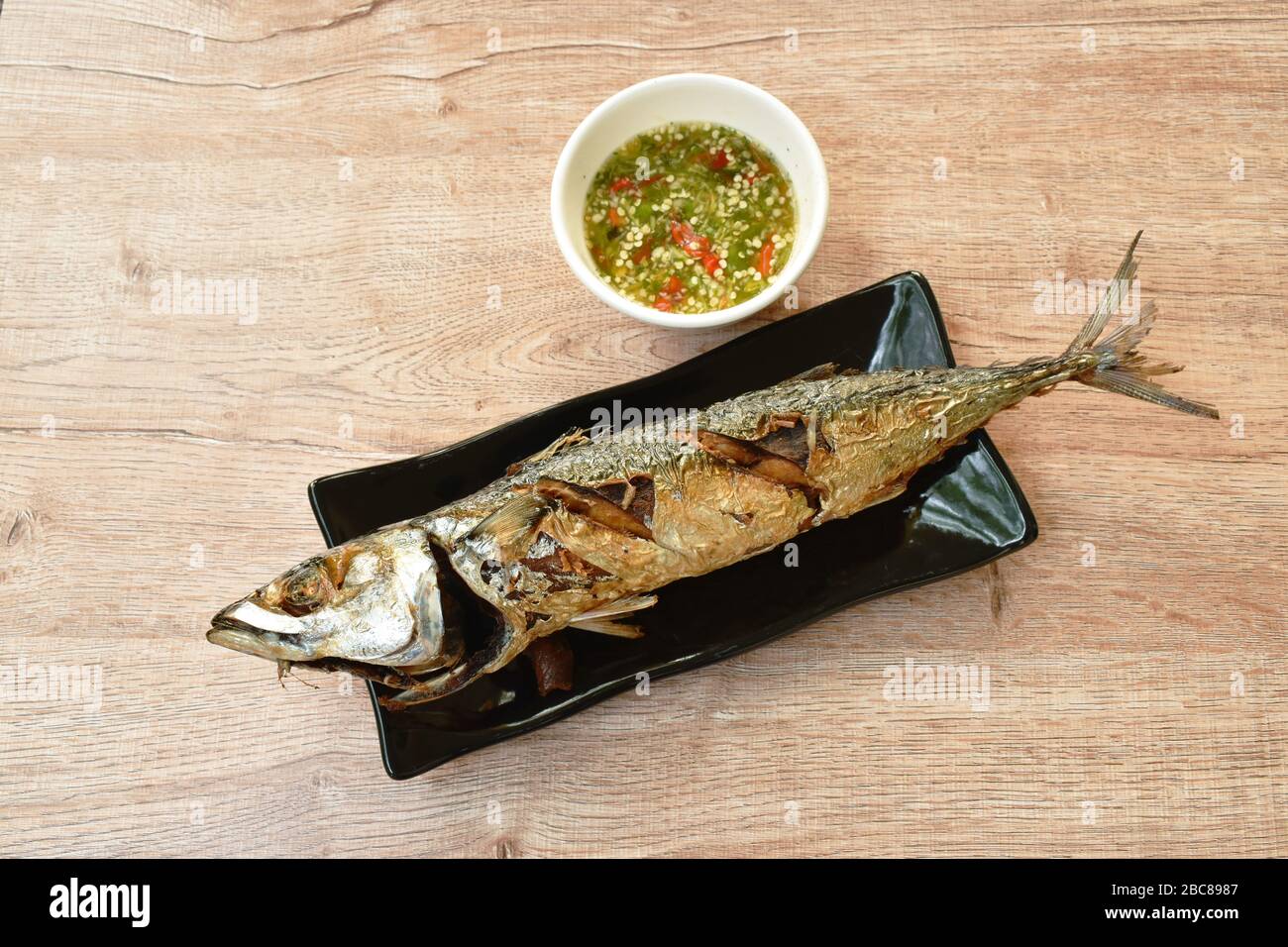 deep fried saba fish or mackerel on plate dipping spicy sauce Stock ...