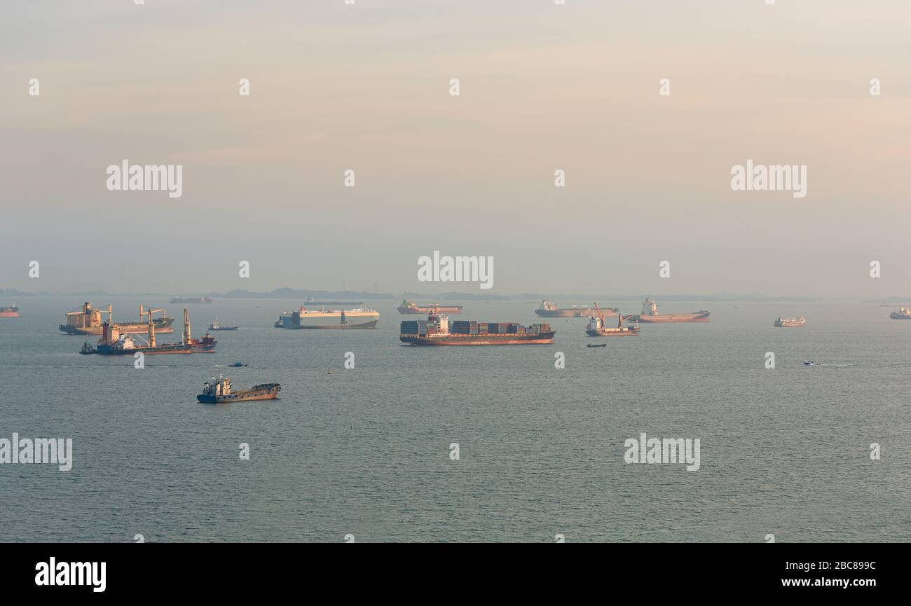 Cargo ships, oil tankers and bulk carriers anchored offshore along the ...
