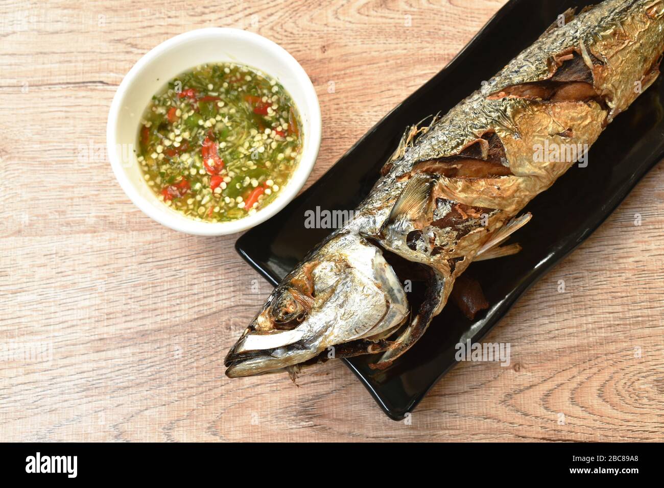 deep fried saba fish or mackerel on plate dipping spicy sauce Stock ...