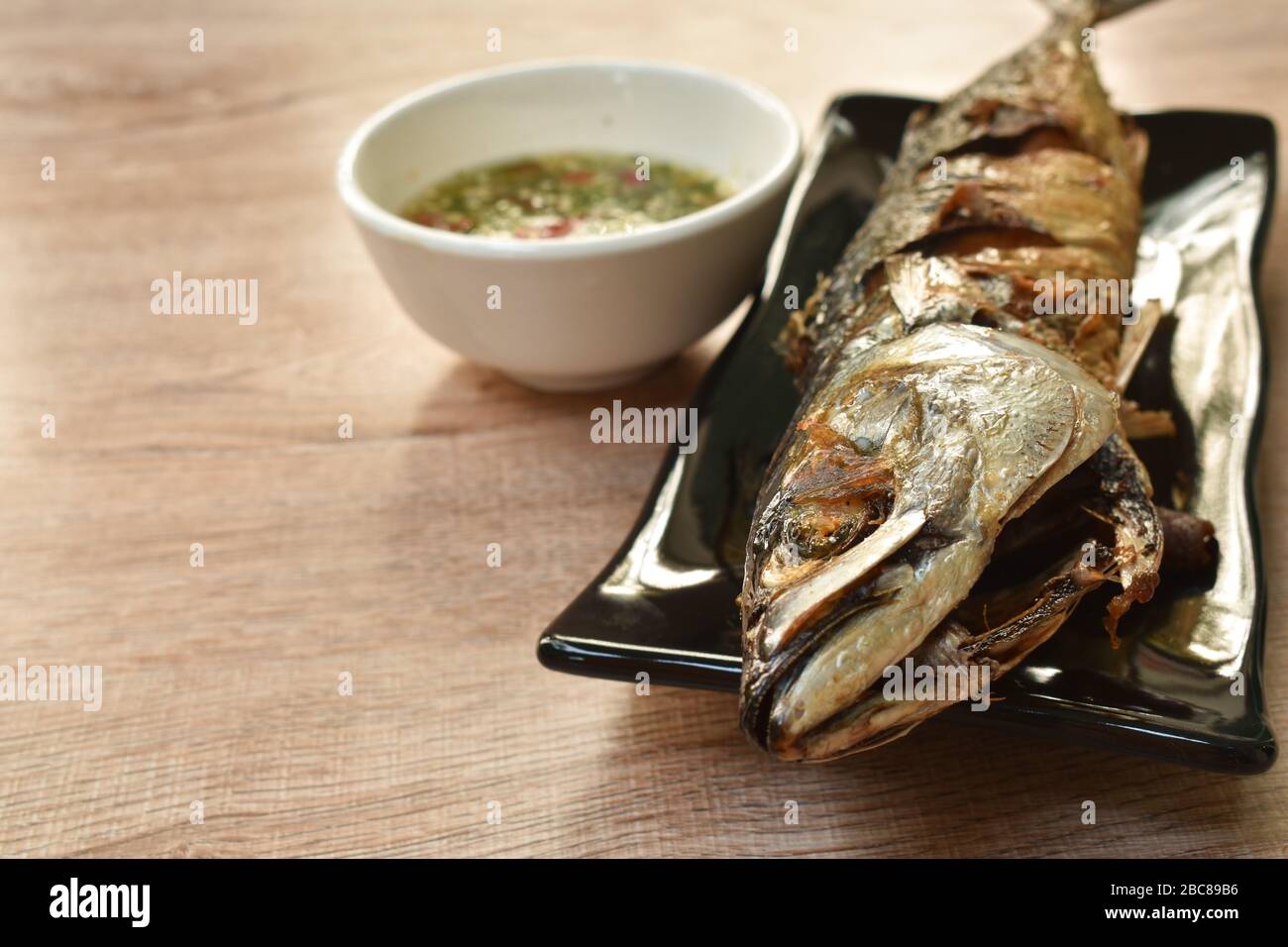 deep fried saba fish or mackerel on plate dipping spicy sauce Stock ...