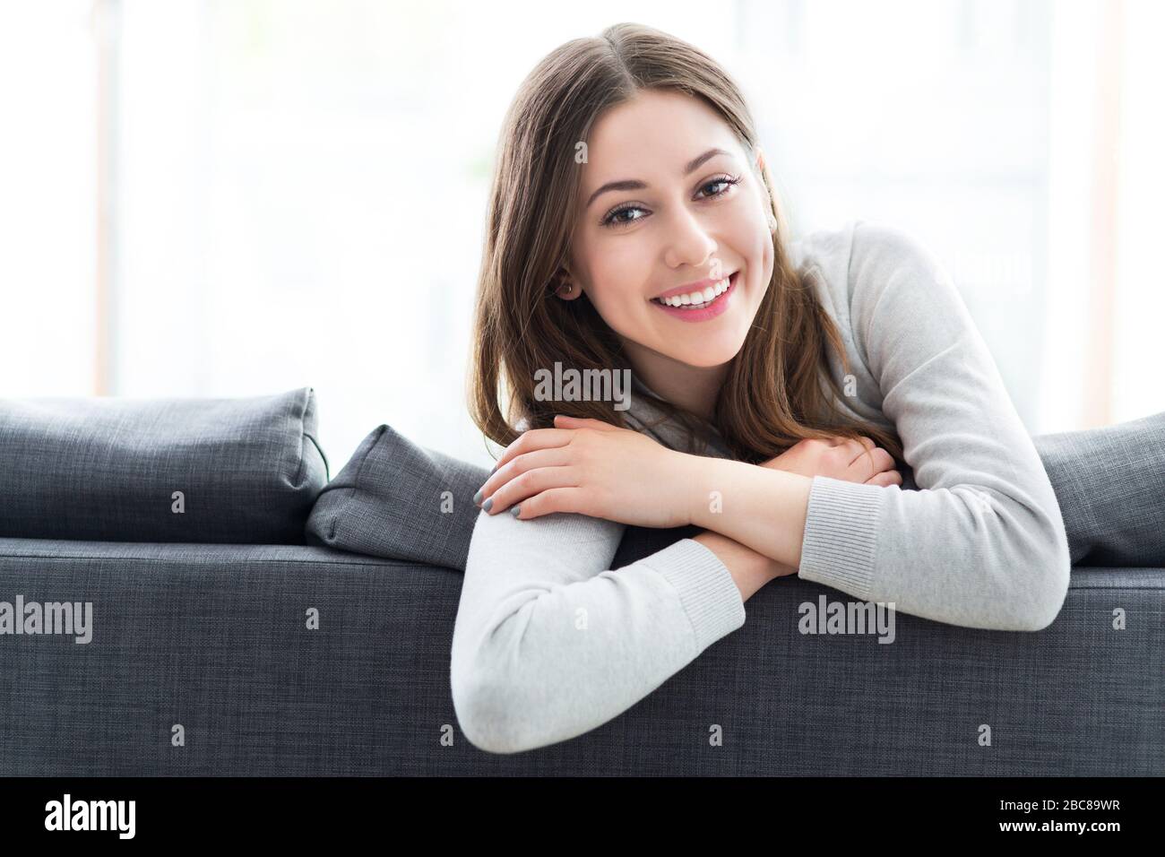 Young woman relaxing on sofa Stock Photo - Alamy Young woman relaxing on sofa Stock Photo - Alamy