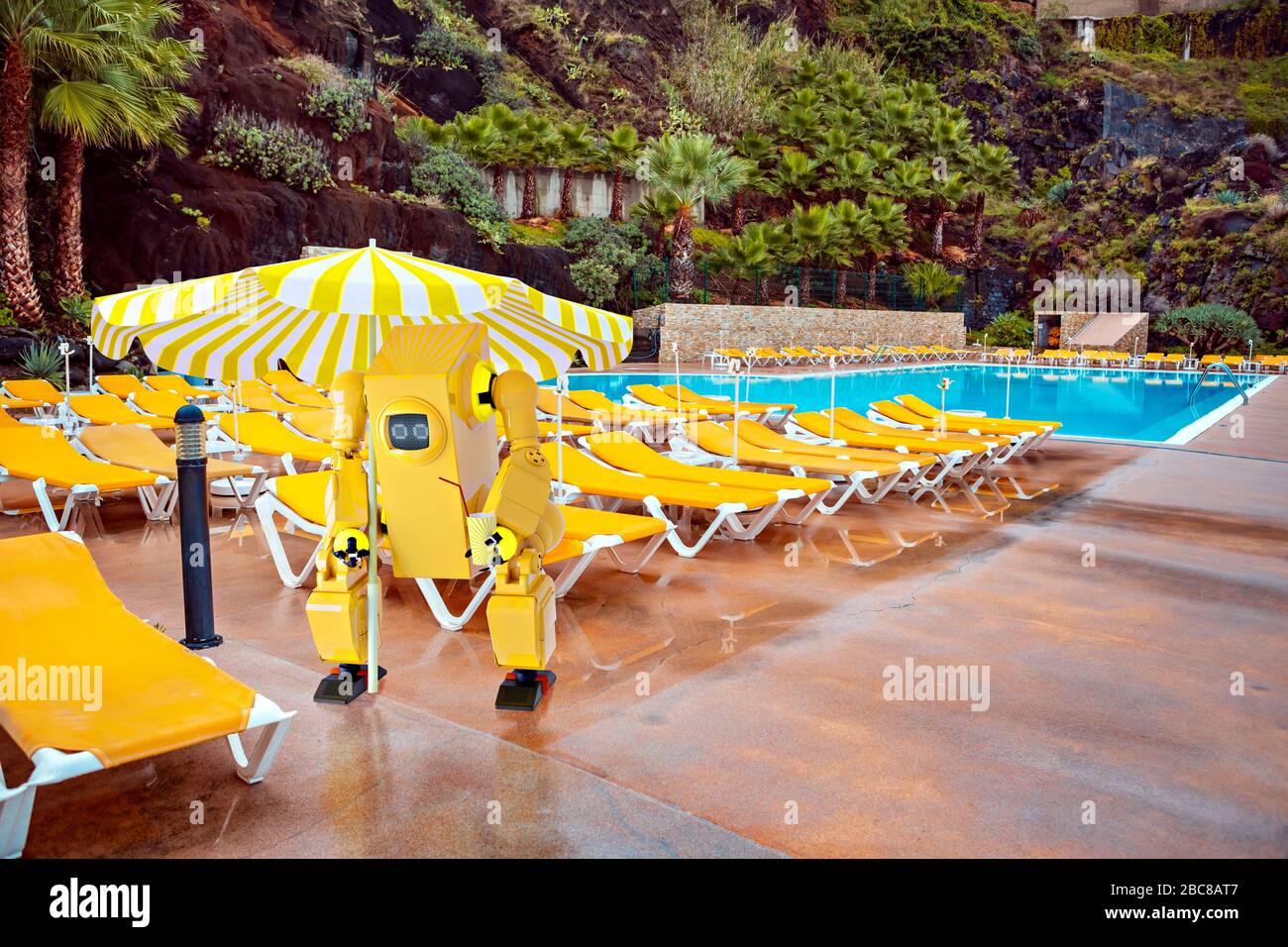 A sad robot on holiday in the empty outdoor pool area Stock Photo - Alamy
