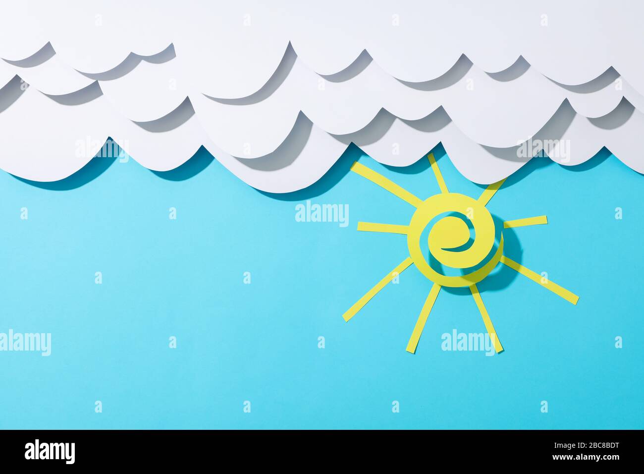 Paper clouds and sun on blue background. Travel Stock Photo - Alamy