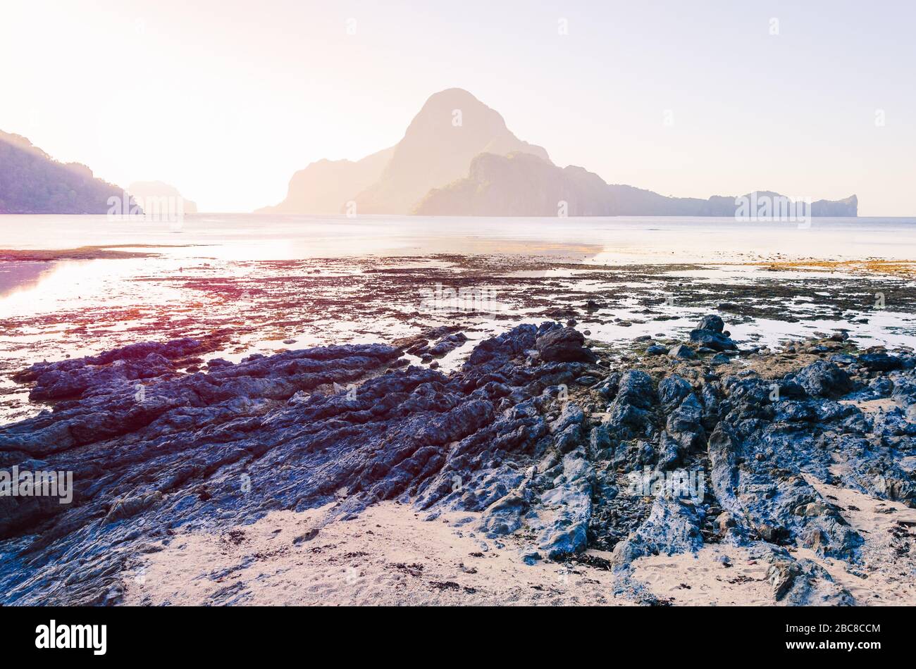 Low tide with Rocks in front and on sunrise and amazing shape of Cadlao ...