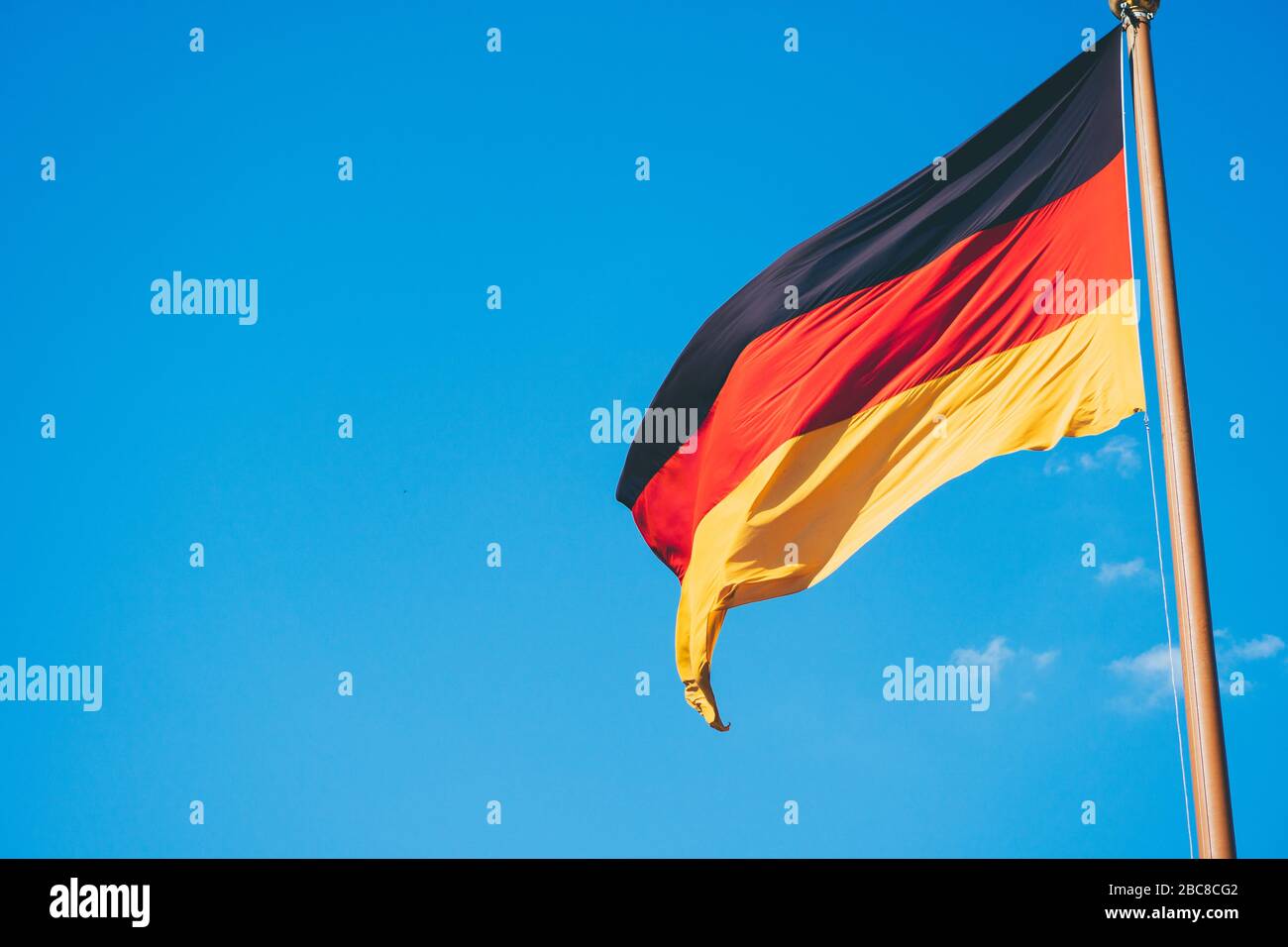 German national flag on blue sky background Stock Photo - Alamy