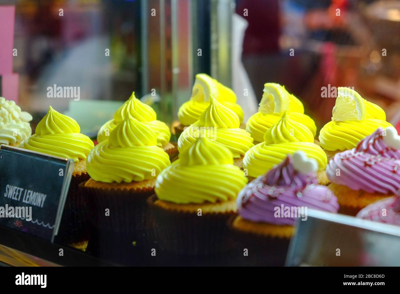 Colorful cupcake in the showcase Stock Photo - Alamy