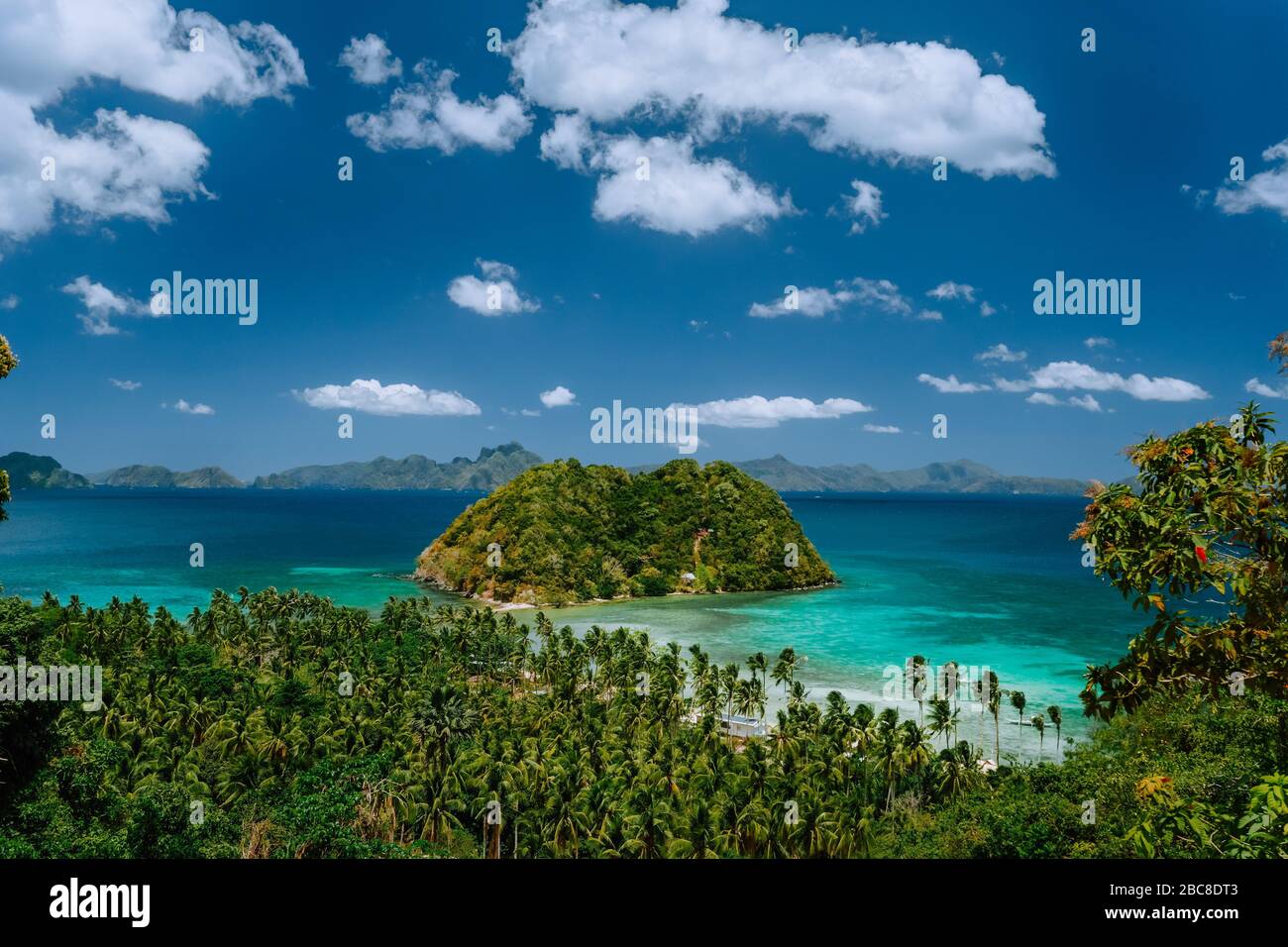 Tropical beach scenery with palm trees, island and blue lagoon. El Nido ...