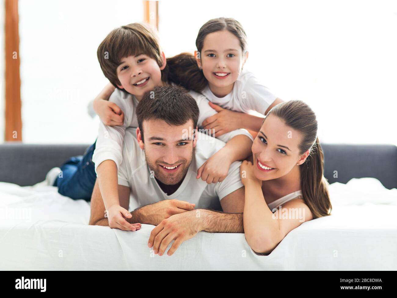 Young family relaxing at home Stock Photo - Alamy