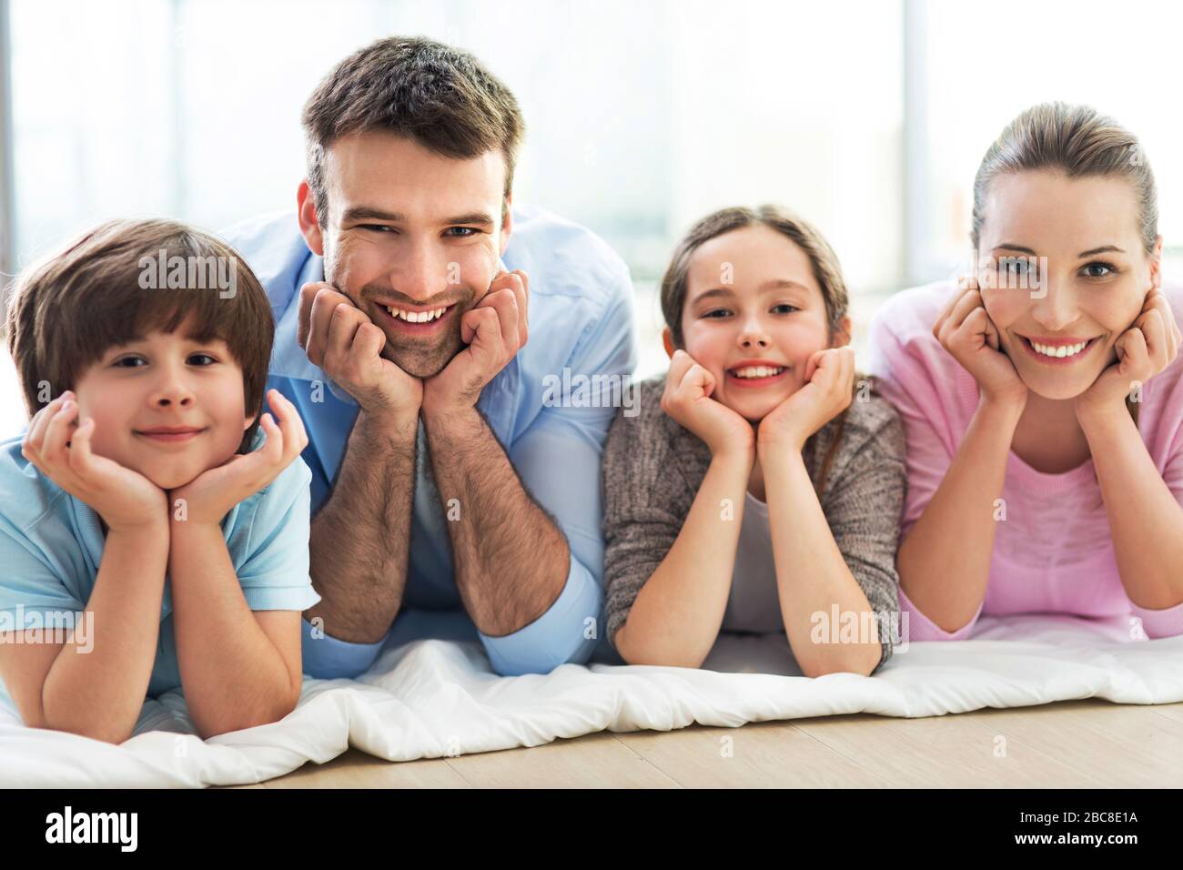 Young family relaxing at home Stock Photo - Alamy