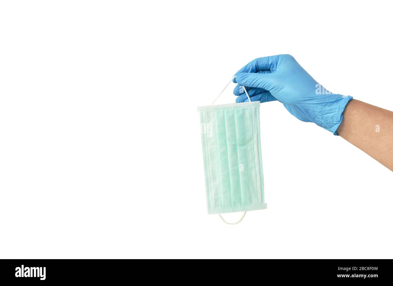 hand in blue rubber glove holding hygienic mask for protection nose and ...