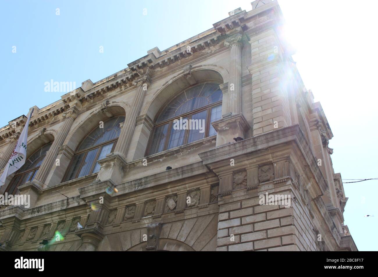 Sun over Greek building Stock Photo - Alamy