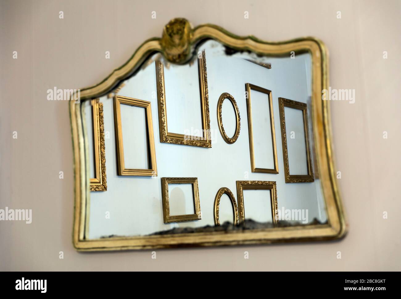 an empty room with empty art frames reflecting in a mirror Stock Photo ...