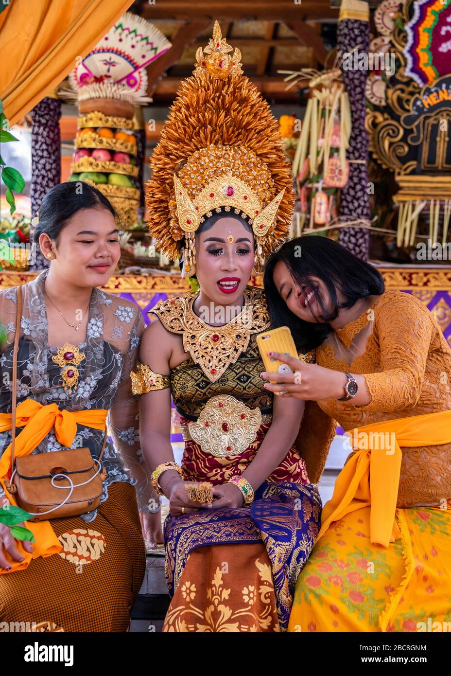 Vertical portrait of the bride and her friends at a Balinese wedding ...