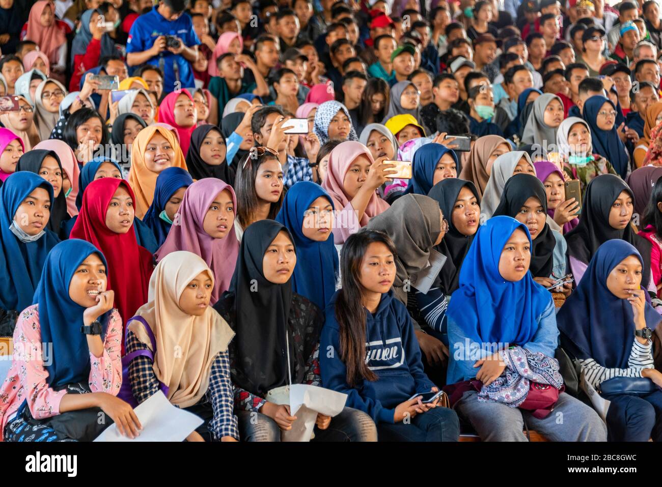 Horizontal view of lots of Muslim students in an audience in Bali ...