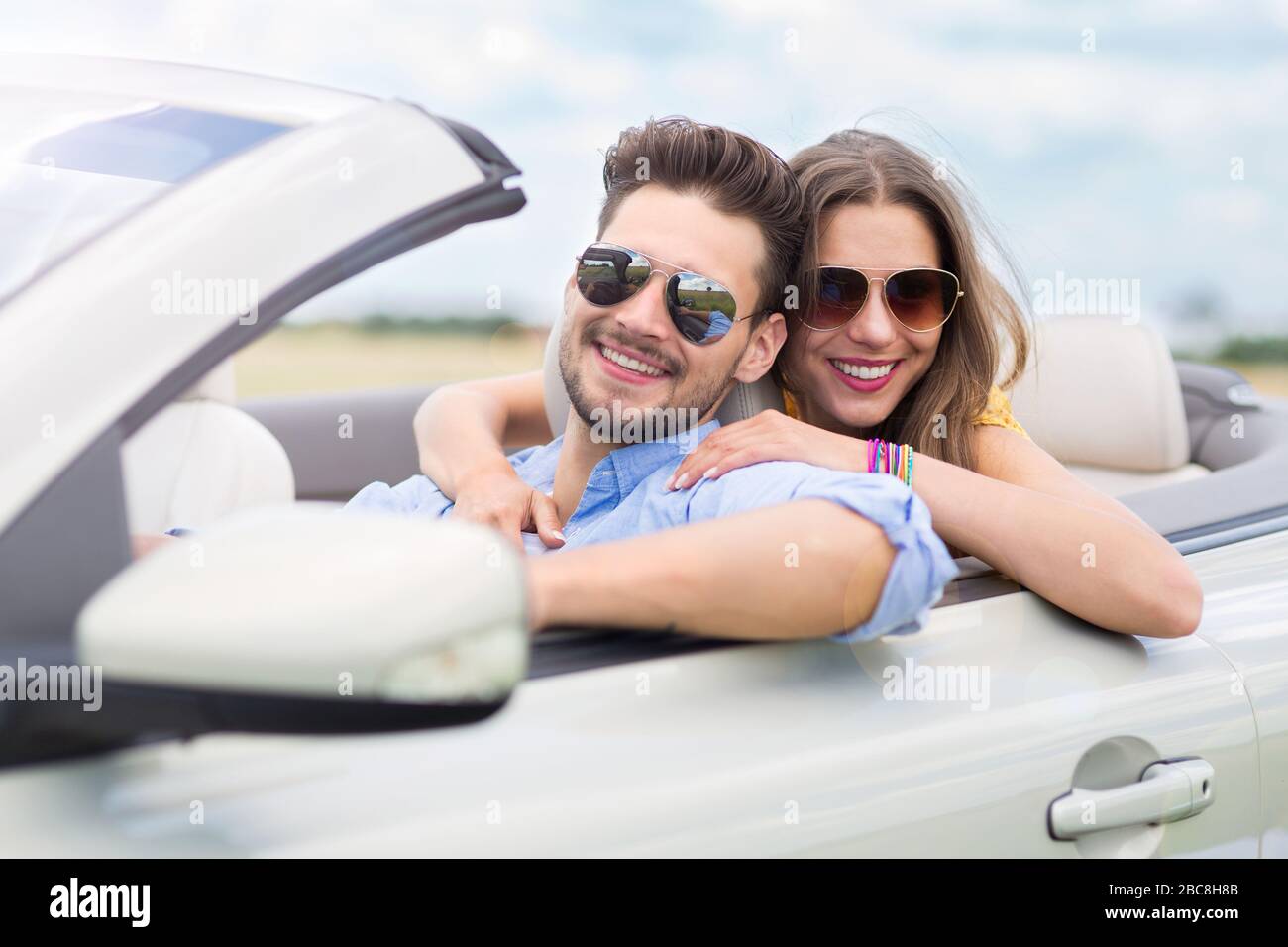 Couple enjoying a drive in a convertible Stock Photo - Alamy
