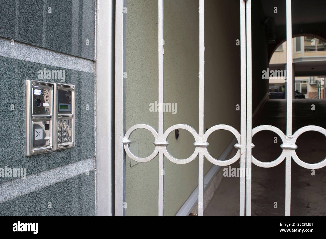 Built into the wall panel intercom with a gate and a prospect of the ...