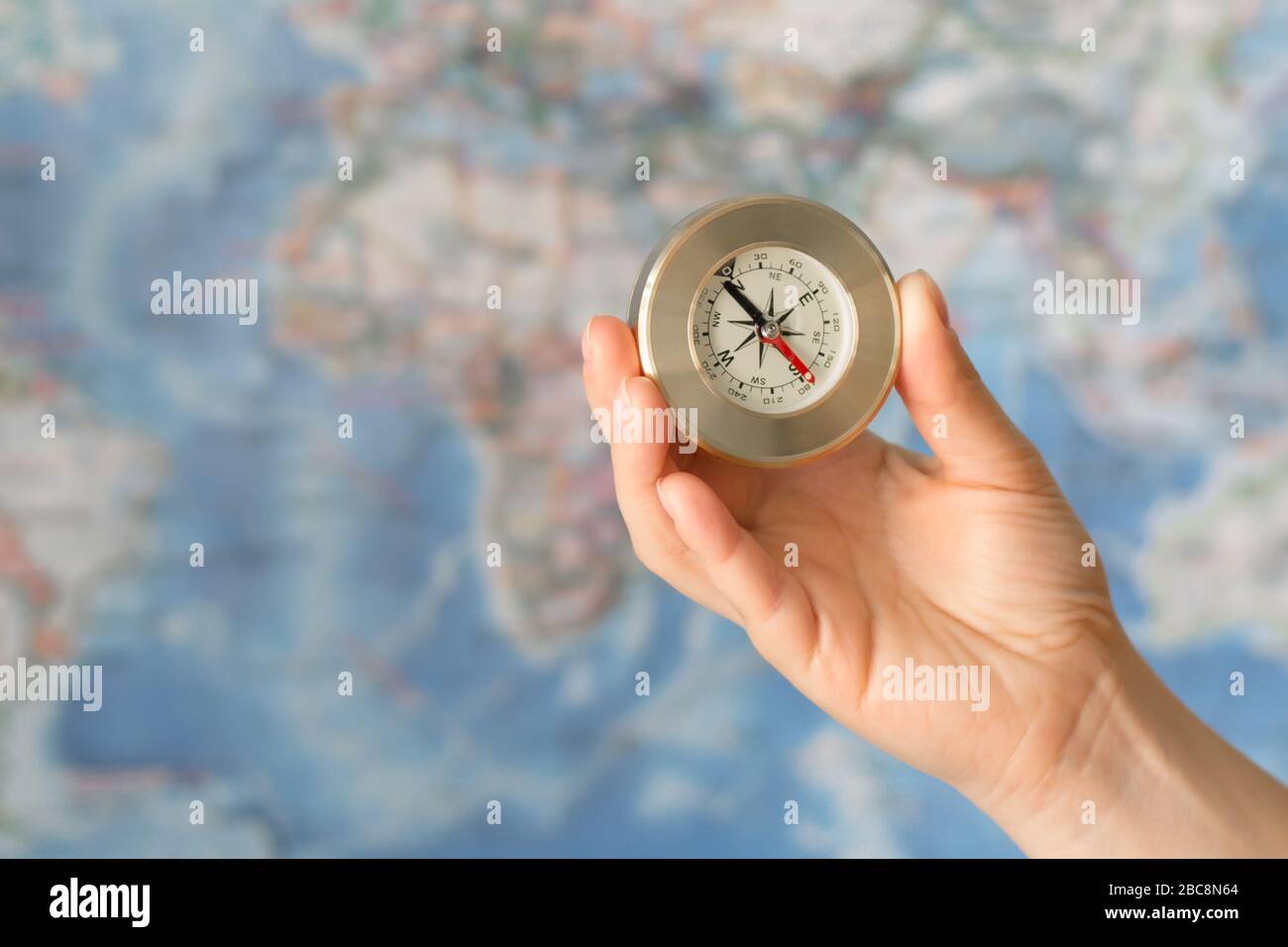Hand holding compass on the background of map Stock Photo - Alamy