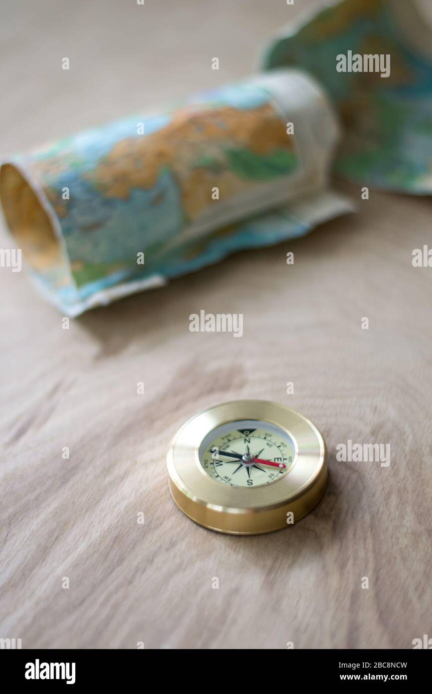 Map and compass lying on wooden background Stock Photo - Alamy