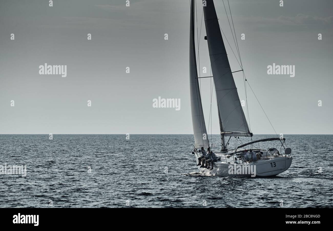Sailboats compete in a sail regatta at sunset, race of sailboats ...