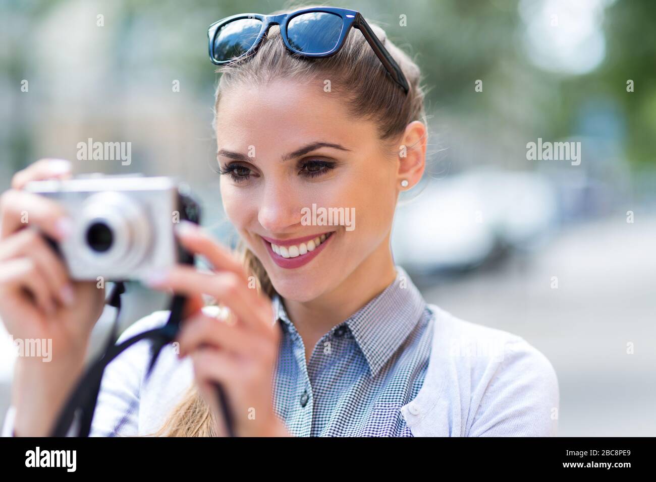 Woman taking photo outside Stock Photo - Alamy