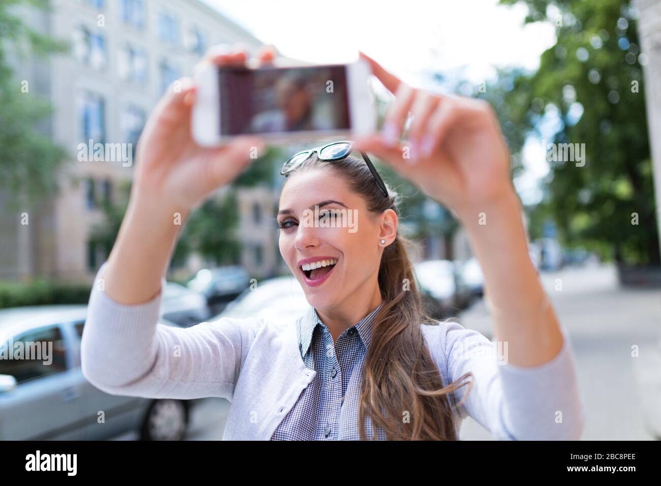 Woman taking photo outside Stock Photo - Alamy