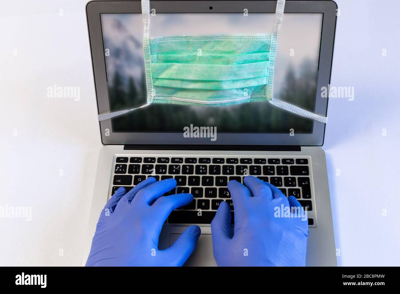 We work on a computer using personal security tools. Mask, gloves Stock ...