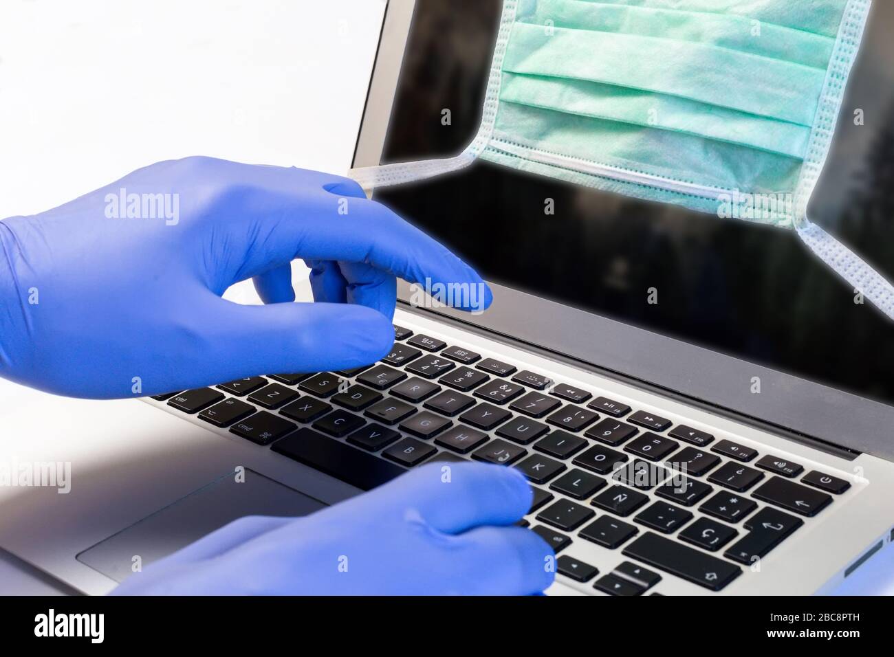 We work on a computer using personal security tools. Mask, gloves Stock ...