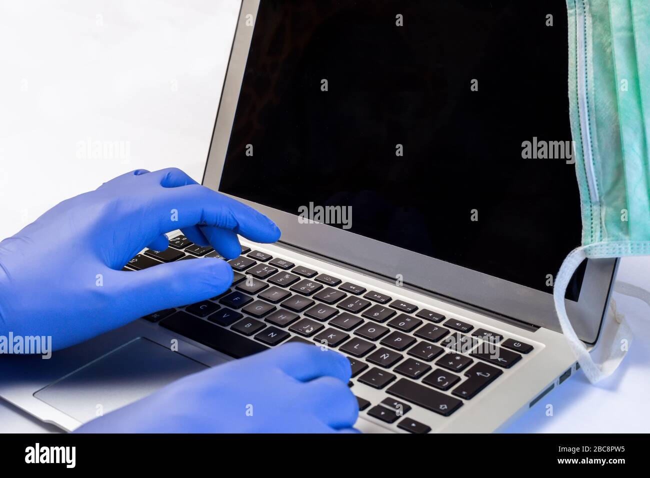 We work on a computer using personal security tools. Mask, gloves Stock ...