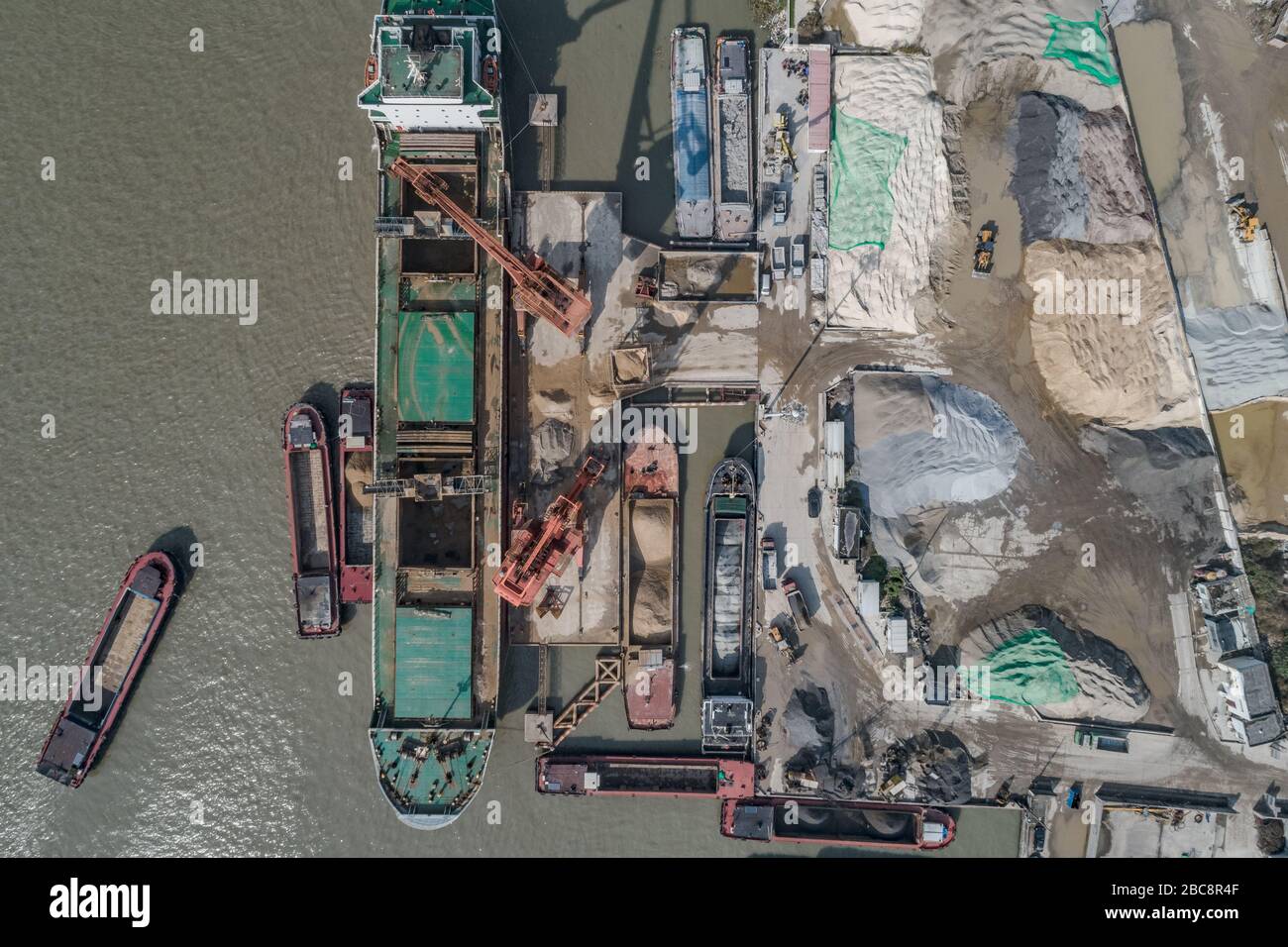 Cargo industrial port, port cranes. Loading of the sand mine Stock ...