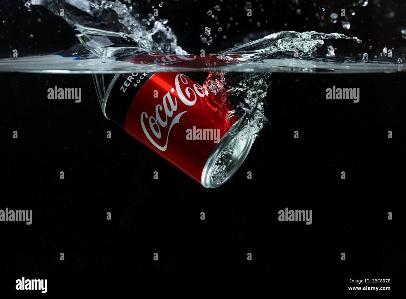 Close up view of can falling in water. Coca cola Stock Photo - Alamy