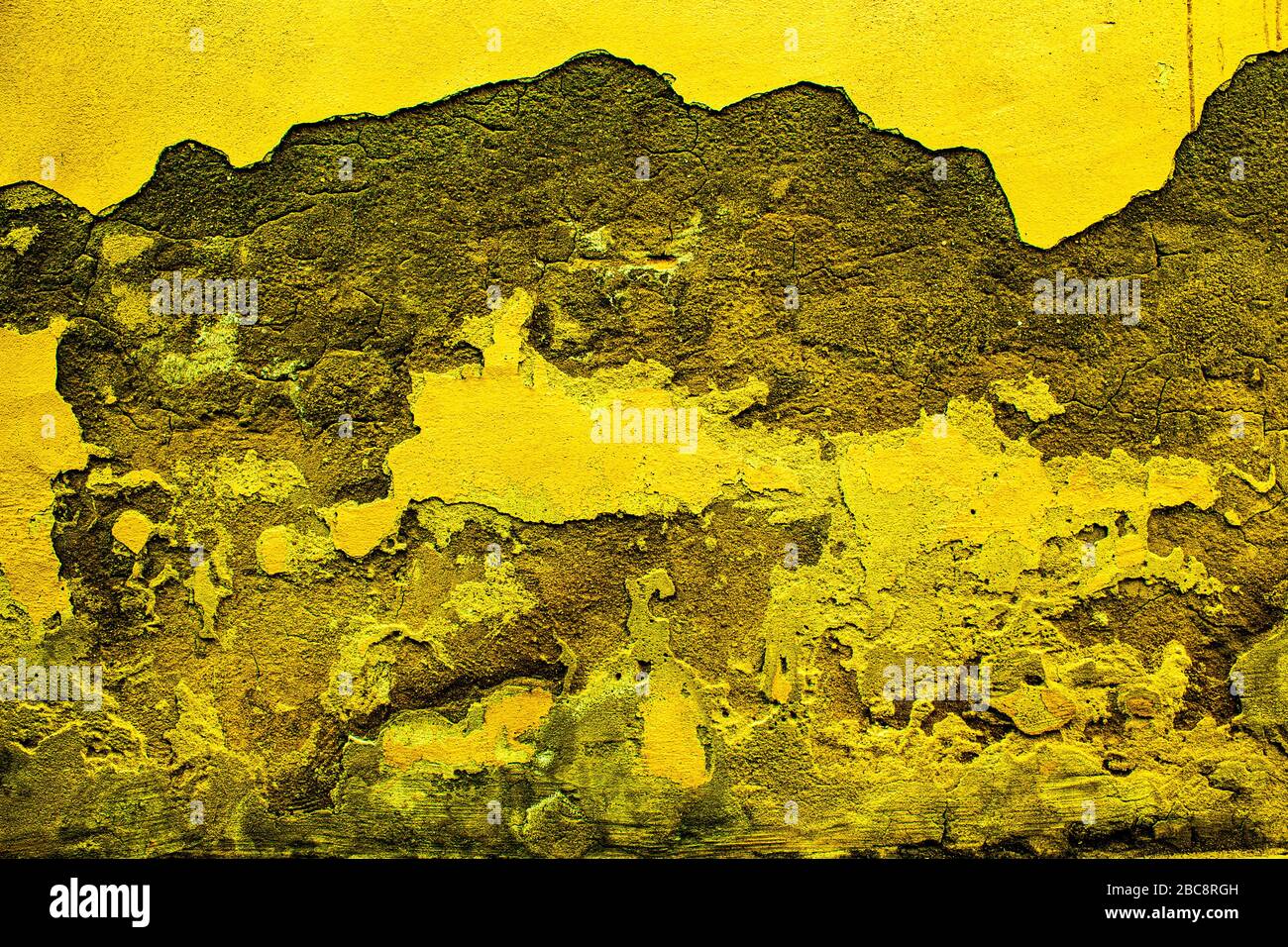 Yellow colored abstract wall background with textures of different ...