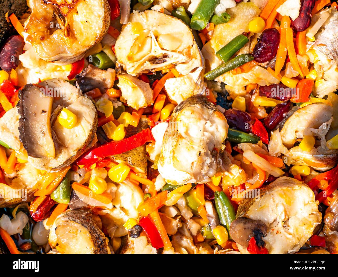 Culinary dish fried fish with vegetable stew Stock Photo - Alamy