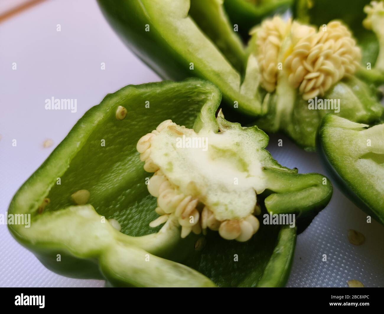 slice of green bell pepper or capsicum isolated on white background ...