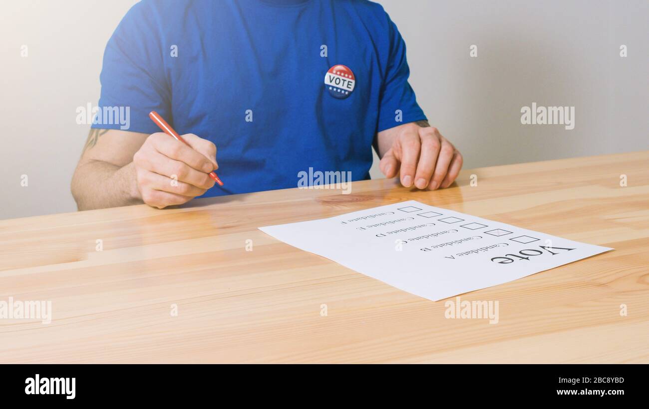 American voter marks his candidate on a paper ballot for US ...