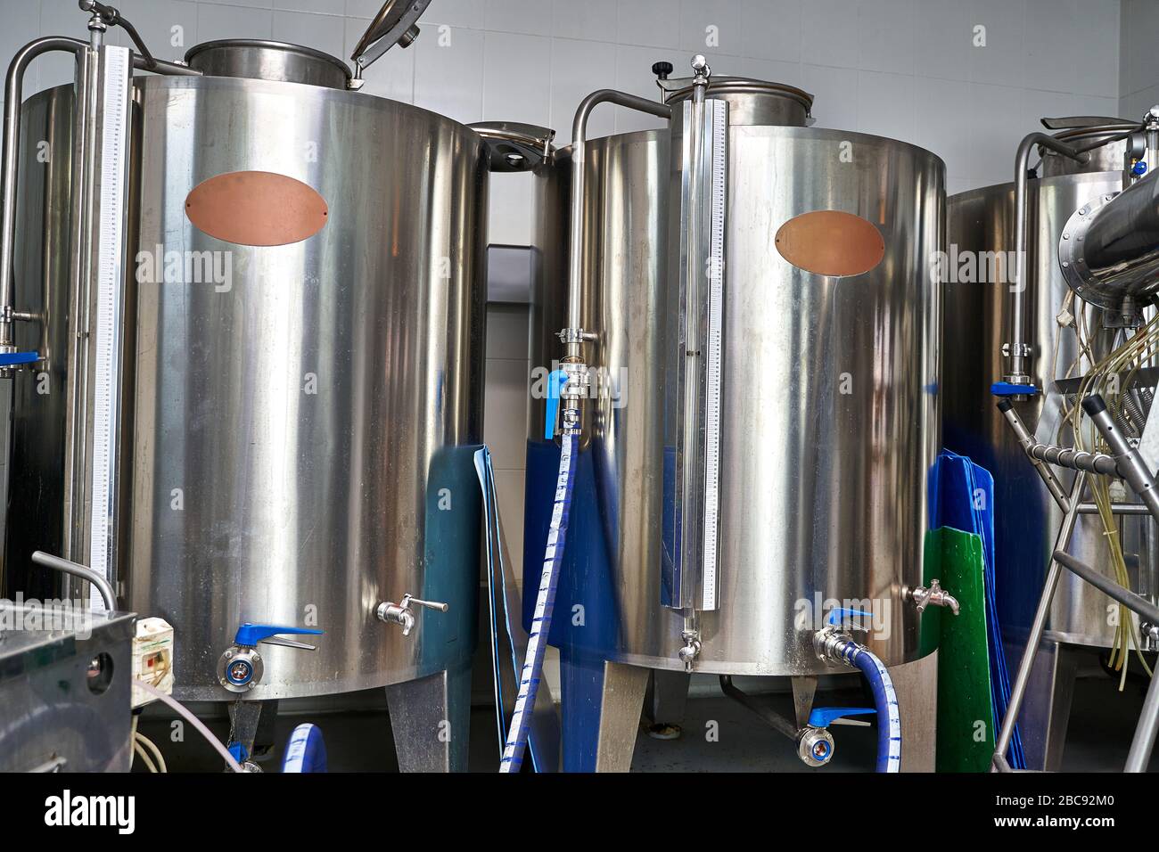 Metallic cylinder-shaped containers in a beer factory. Brewery concept ...