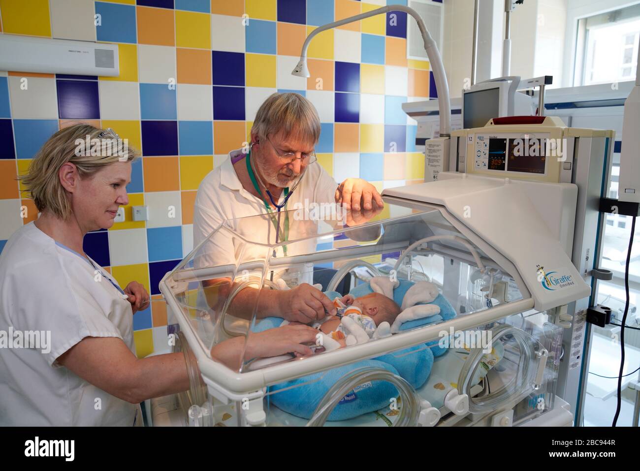 Doctor and nurse during an examination, intensive care unit for ...