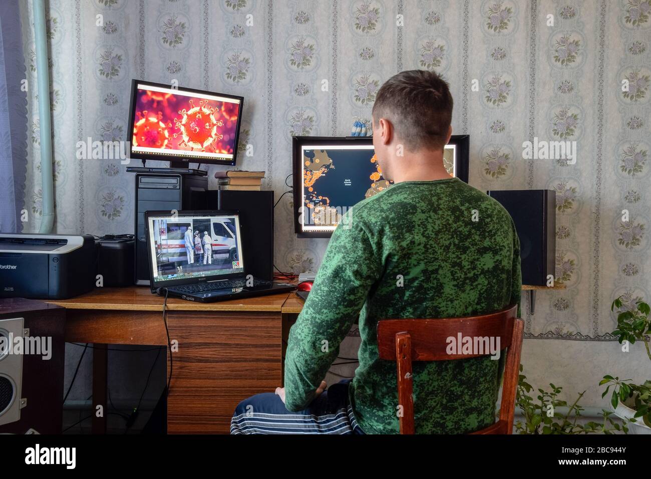 Krasnodar, Russia - April 02, 2020: A man sits at computer monitors and ...